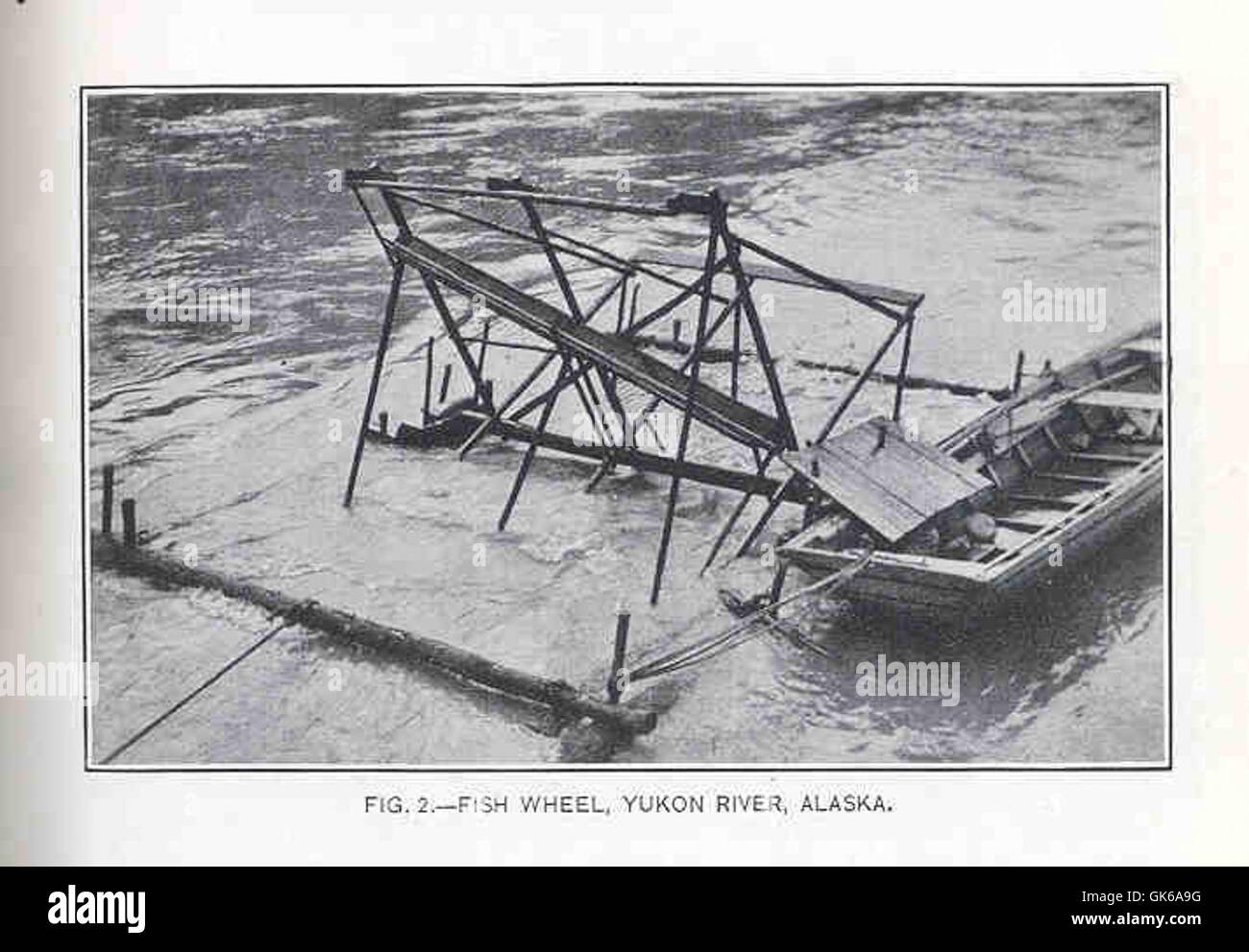 The image shows a traditional fish wheel used for salmon fishing on the ...