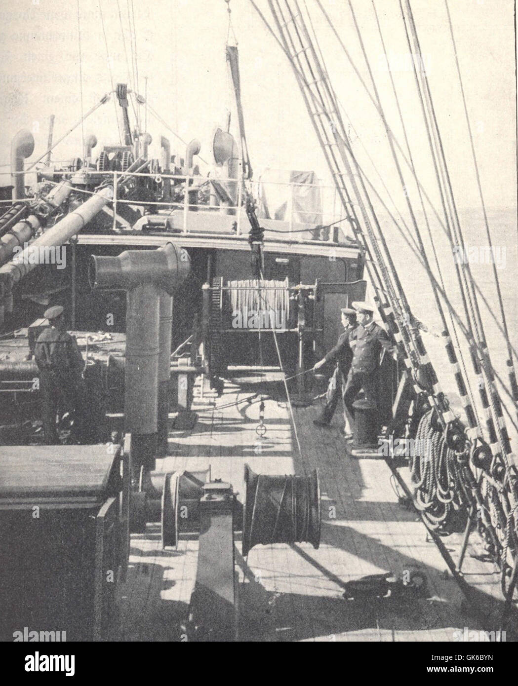 This image depicts a large cable drum and the head of a steam windlass ...