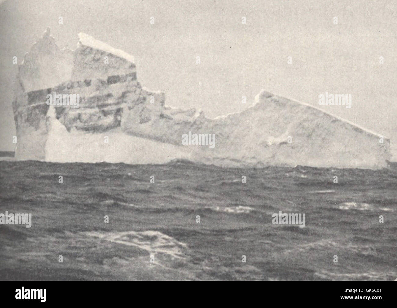 This image shows an iceberg with layers of blue ice, a natural ...