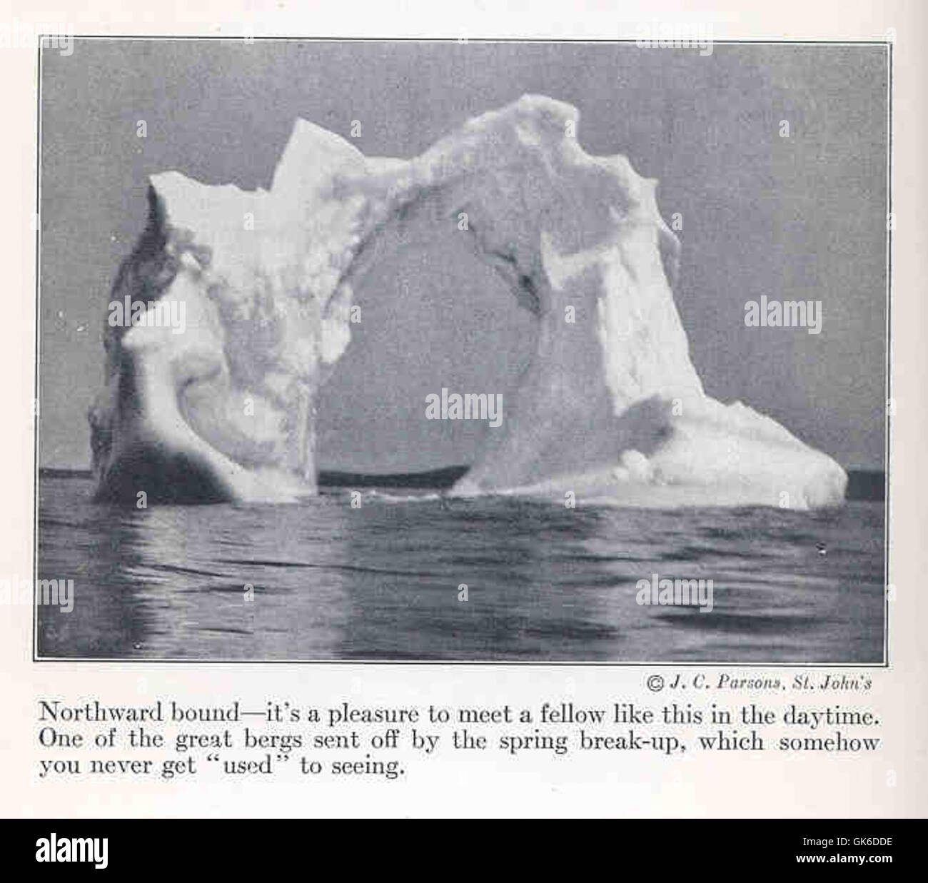 This image depicts a large iceberg drifting northward, a natural ...