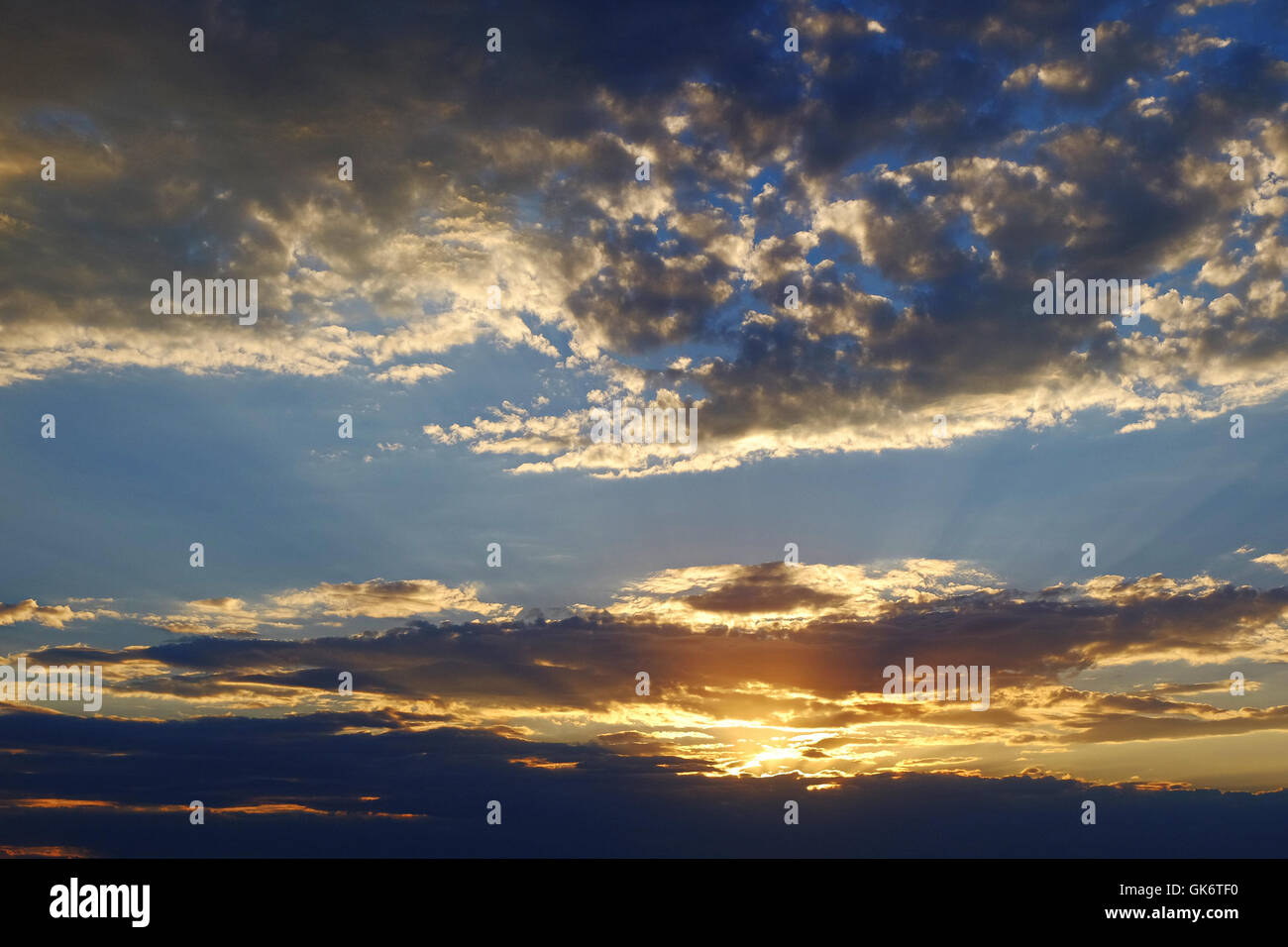 Sunset sky and sun shining from back of clouds Stock Photo - Alamy