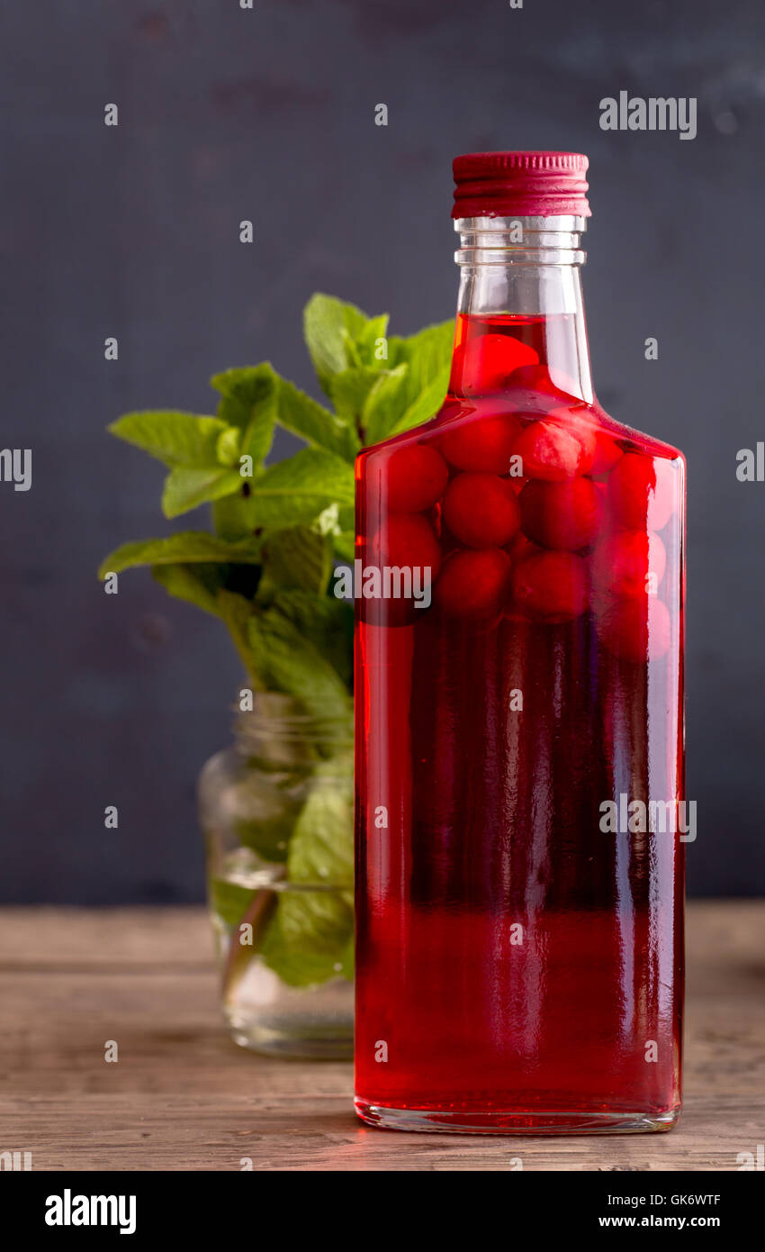 Cranberry alcohol drink in bottle Stock Photo - Alamy