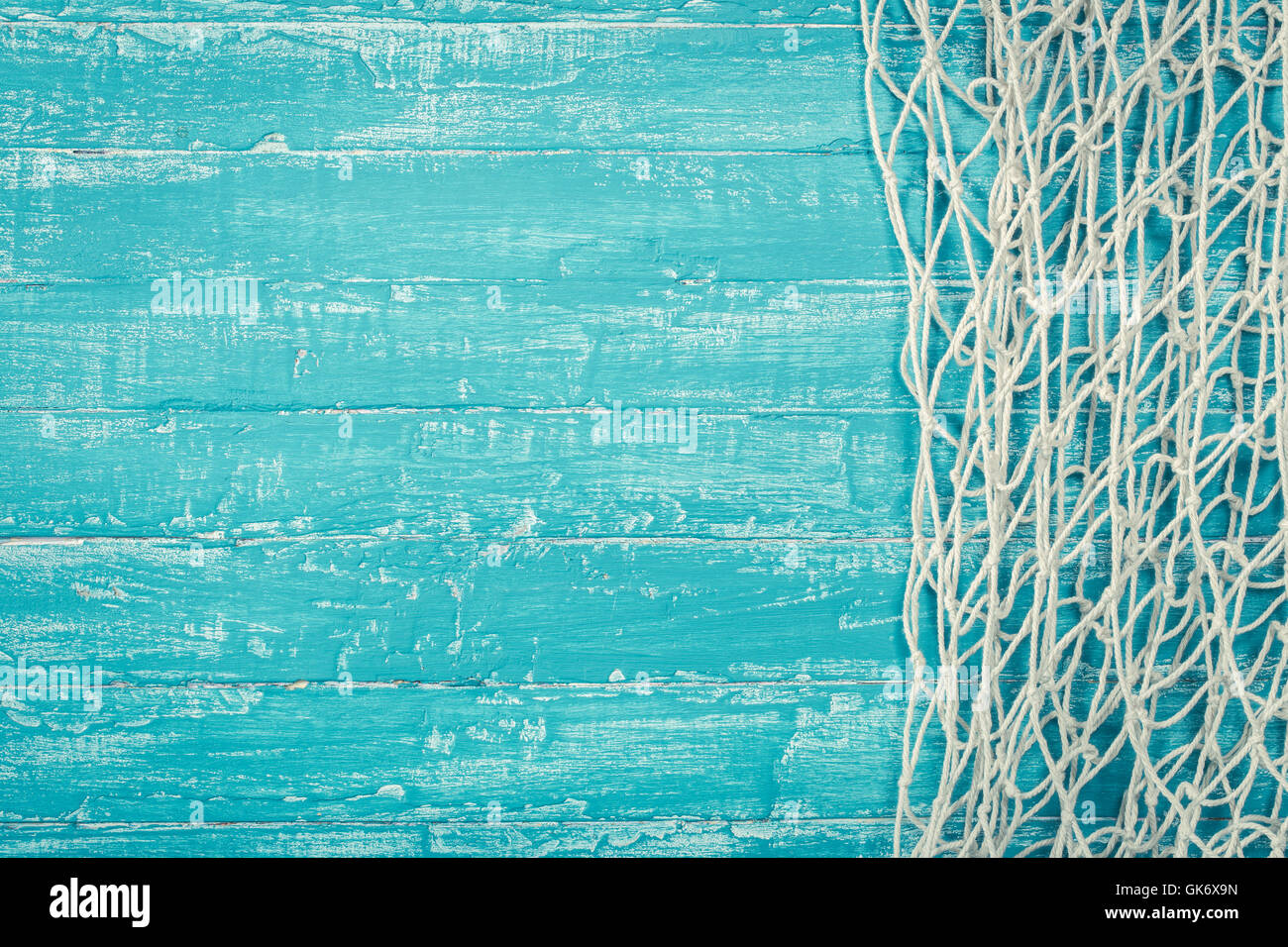 Fishing net from right side of turquoise board Stock Photo - Alamy