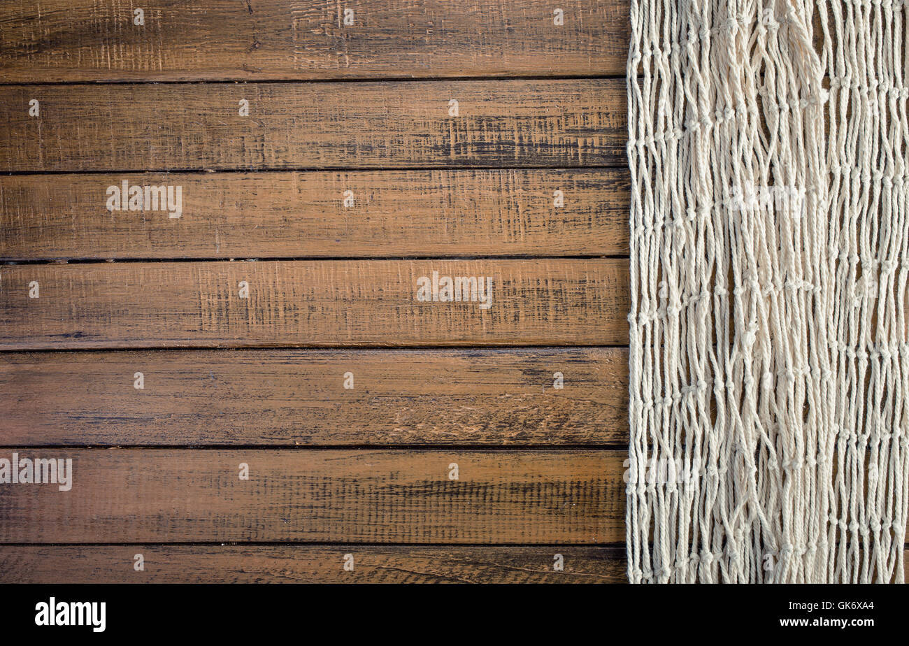 Fishing net on old wooden board Stock Photo - Alamy