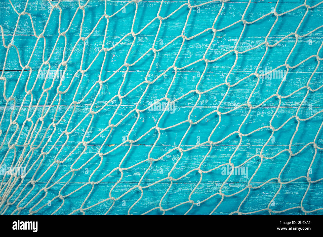 Fishing net over blue background Stock Photo - Alamy