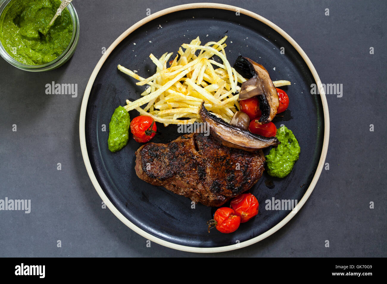 Fillet steak with string fries, roast tomatoes and portobello mushrooms ...