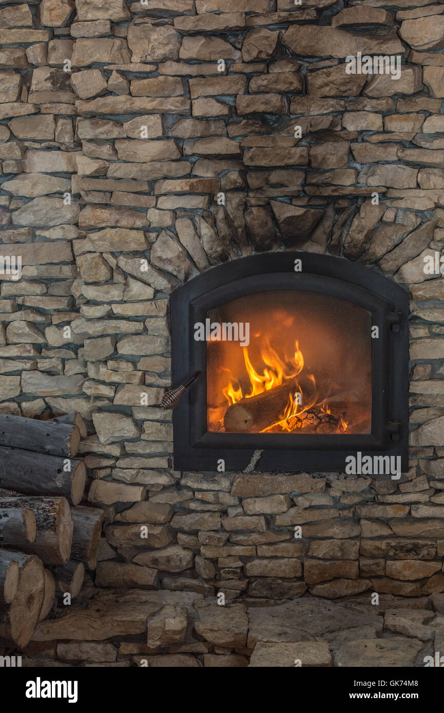 Traditional built in log fire Stock Photo - Alamy
