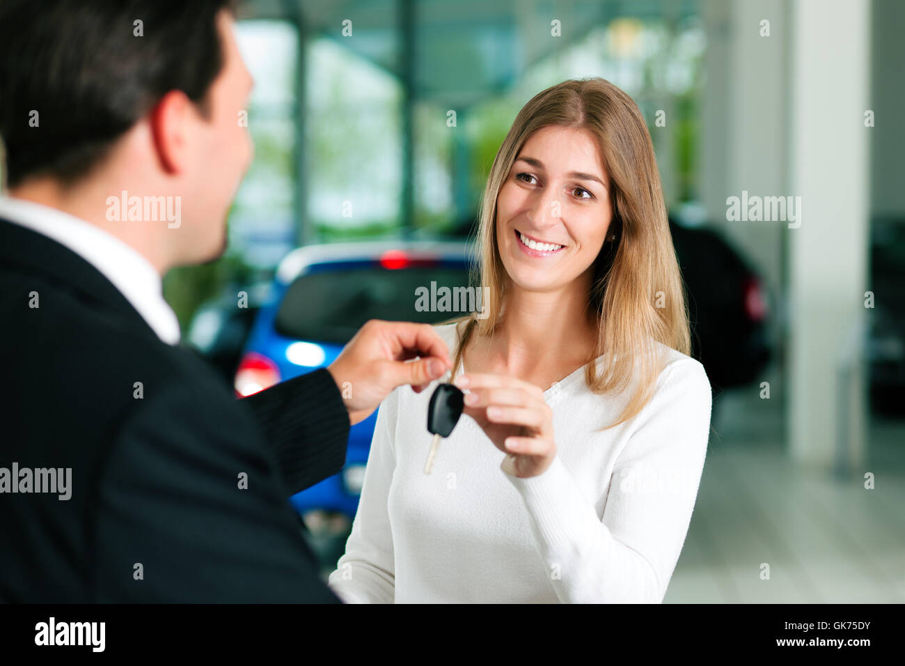woman buying car - key handover Stock Photo - Alamy