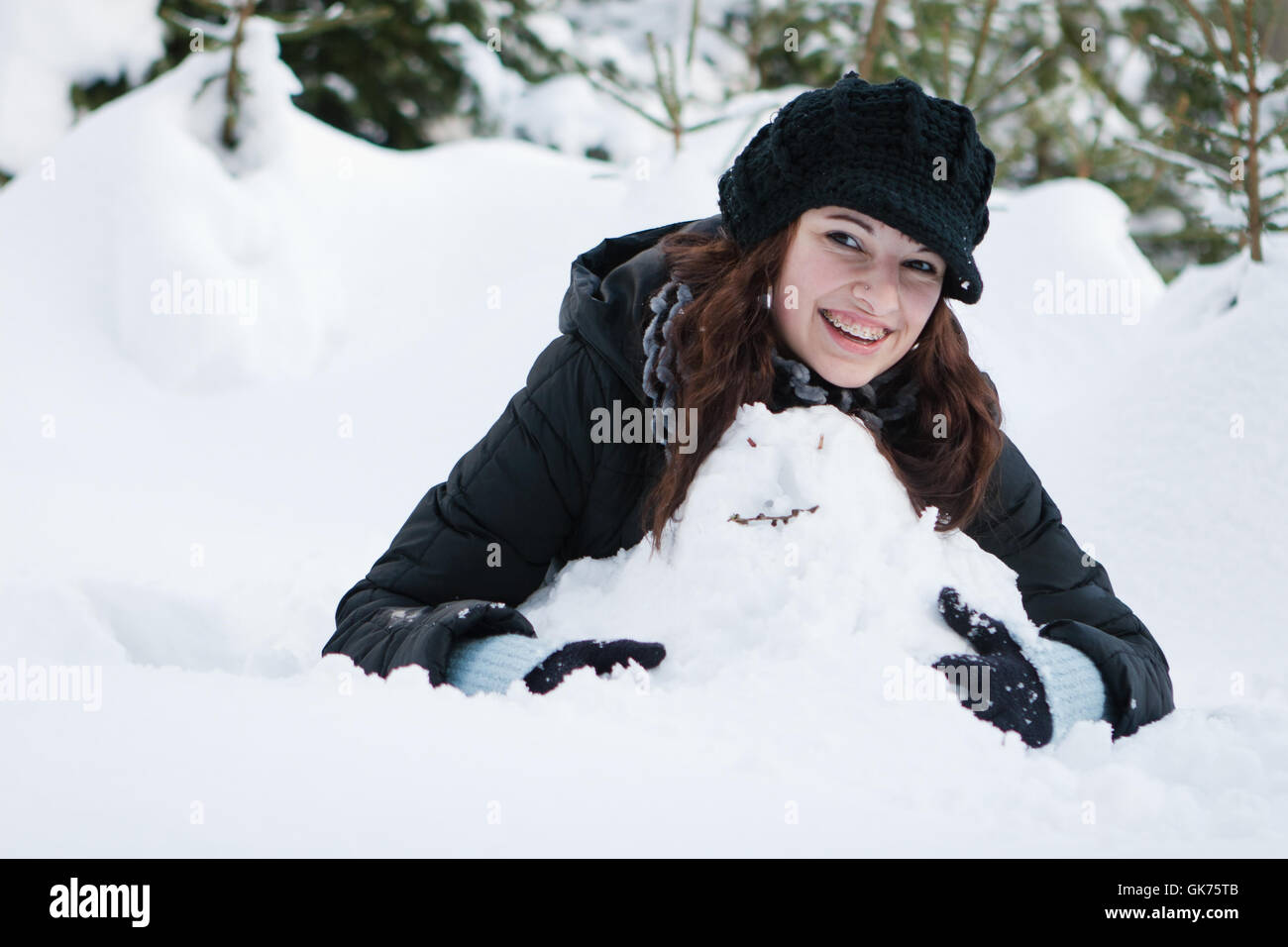 young sympathetic woman with braces builds a snowman Stock Photo - Alamy