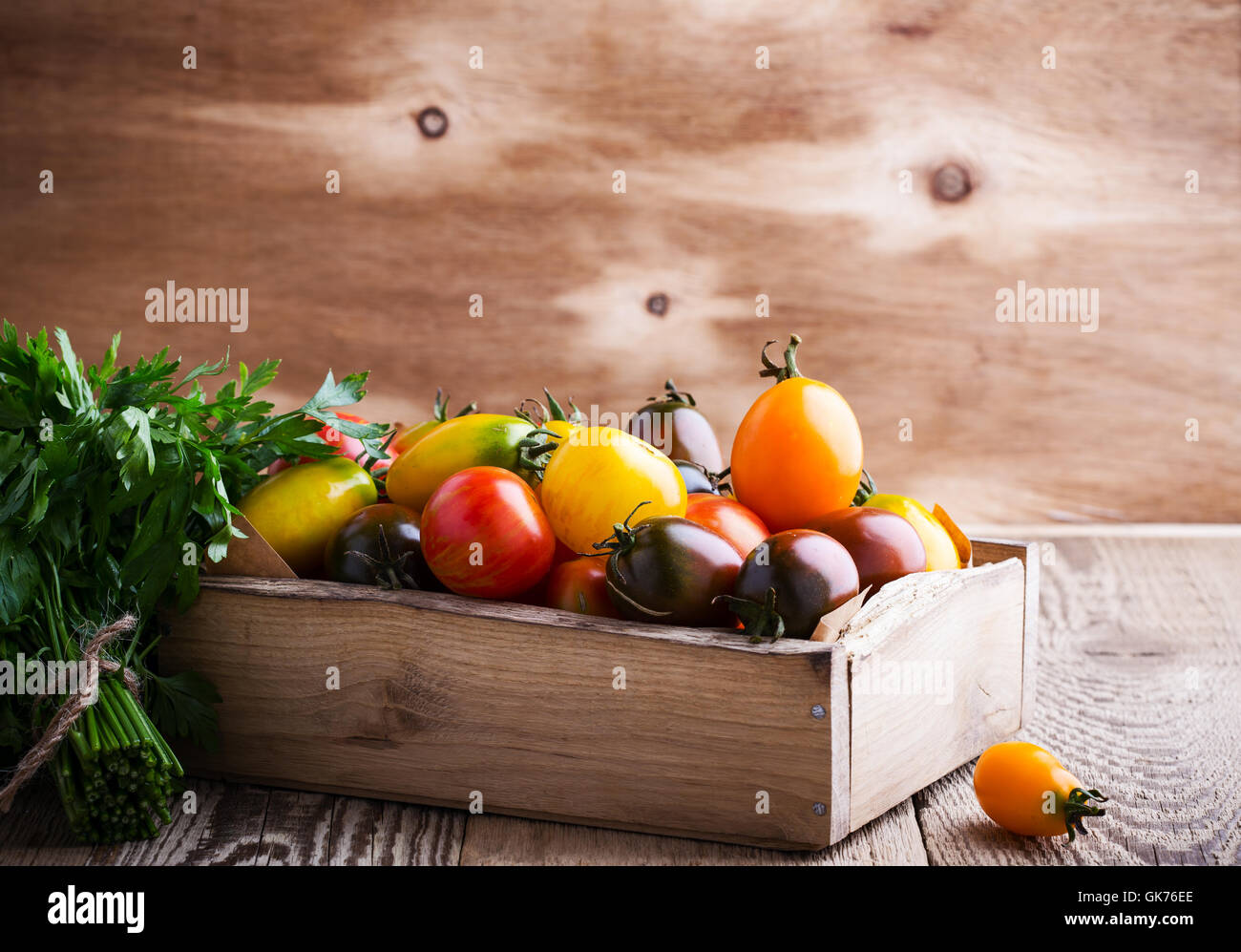 Assorted tomatoes in wooden box. Composition of colorful vegetables in ...