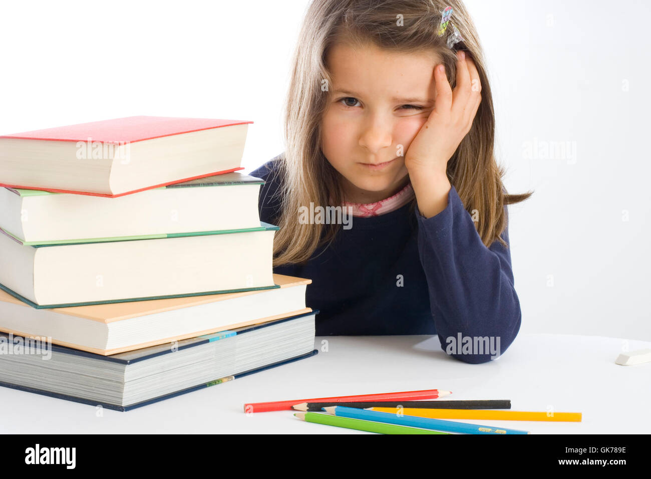 six year old girl sitting listlessly beside books (mr Stock Photo - Alamy