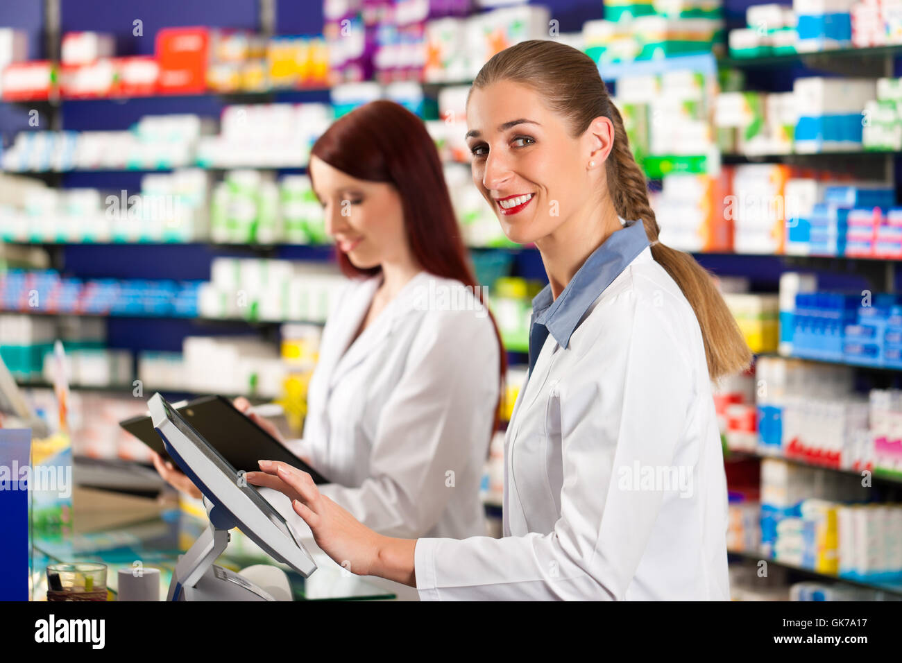 pharmacist with assistant in pharmacy drugstore Stock Photo - Alamy