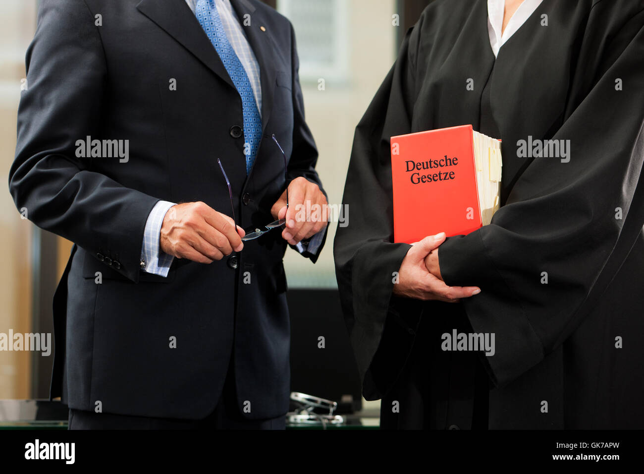 lawyer with statute book and client Stock Photo - Alamy
