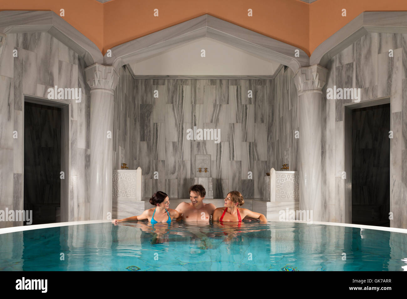 Three friends enjoying swimming pool hi-res stock photography and ...