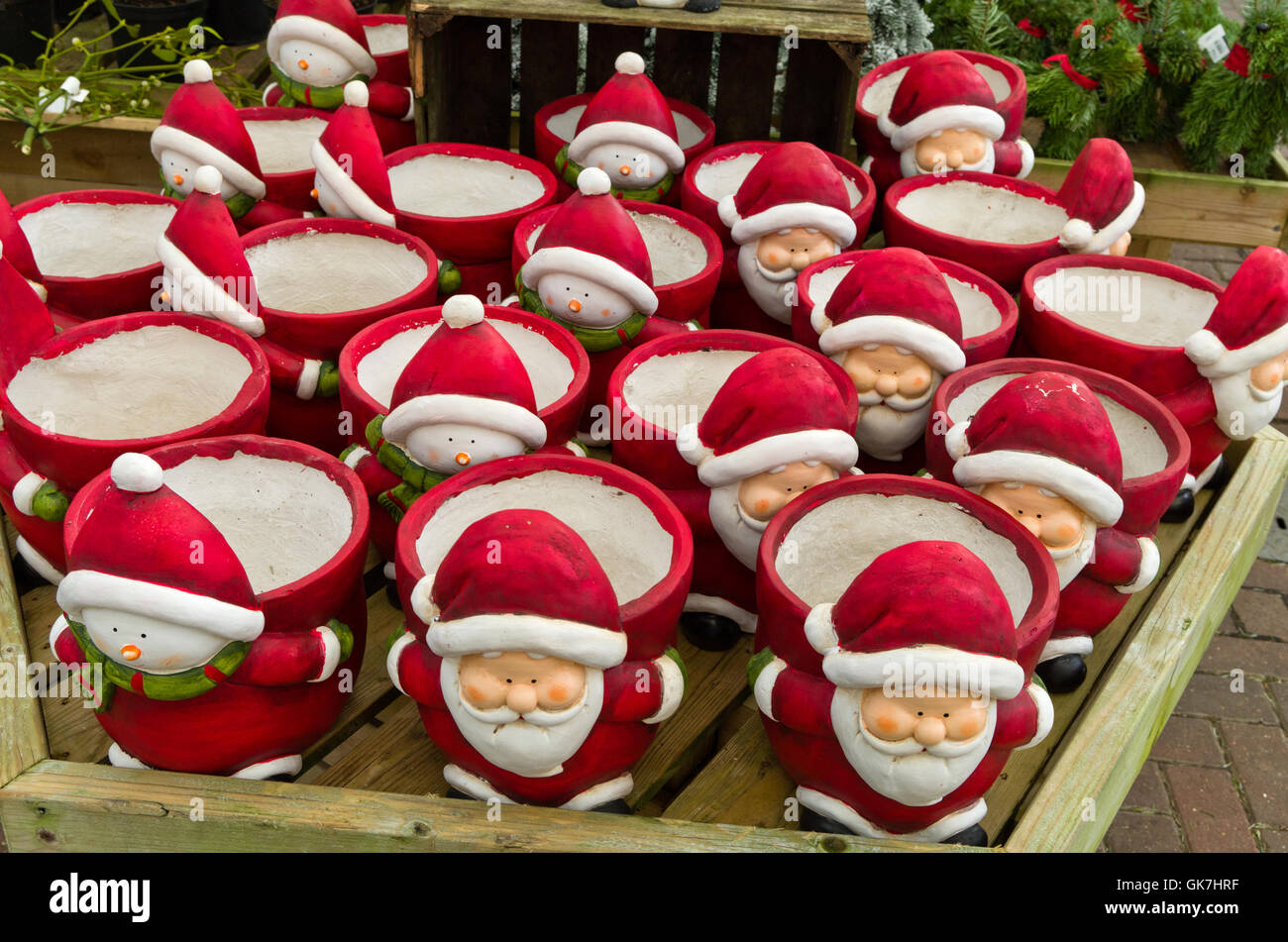 Wooden box filled with novelty red plant pots in the forms of Father ...