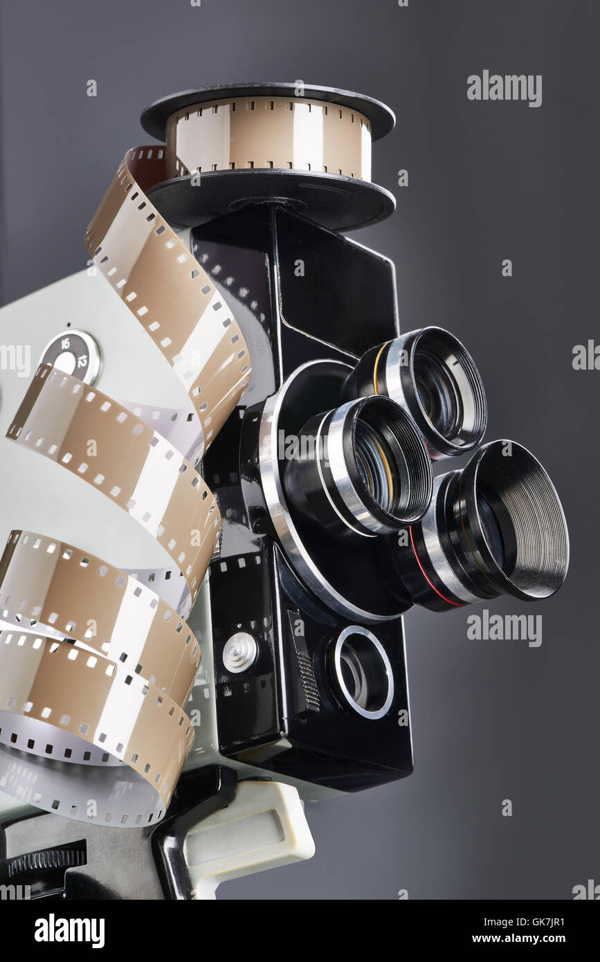 Retro mechanical movie camera and reel film isolated gray Stock Photo ...