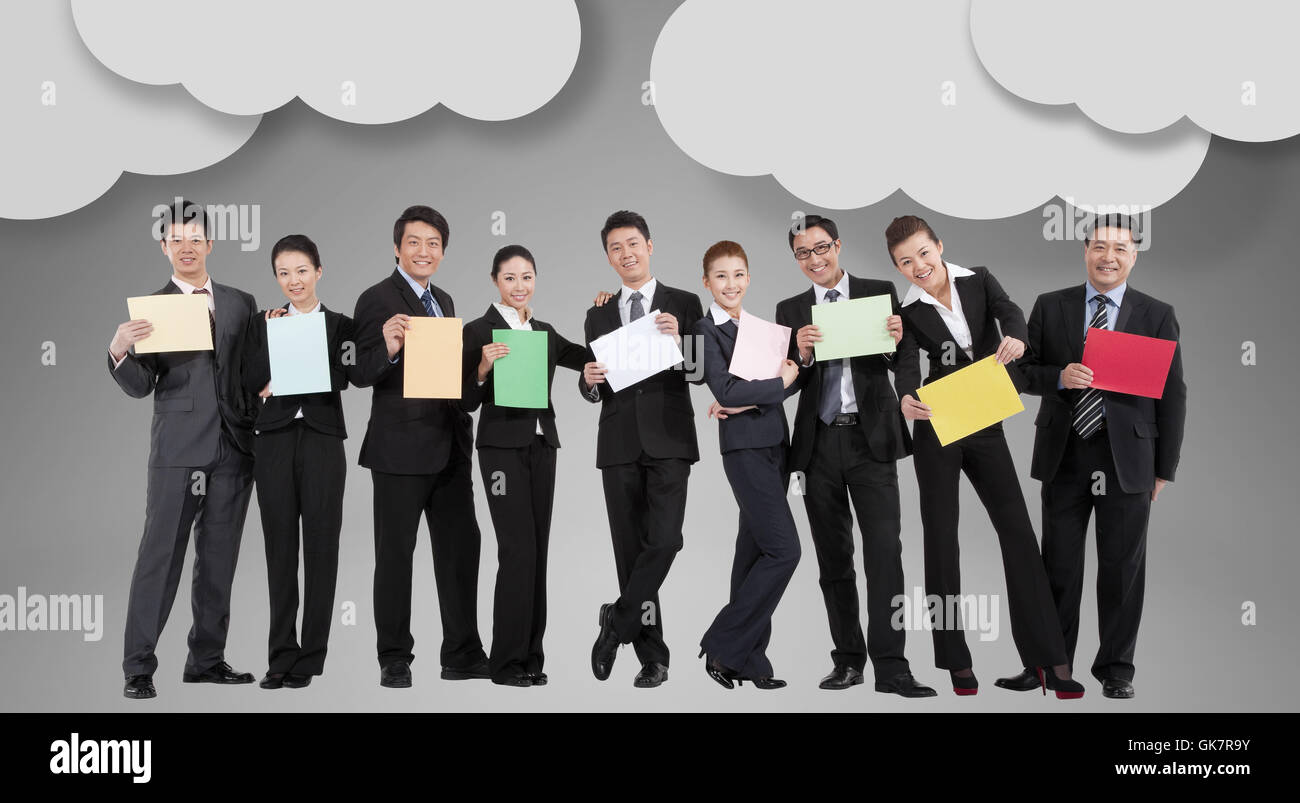 Business team holding a white board Stock Photo - Alamy