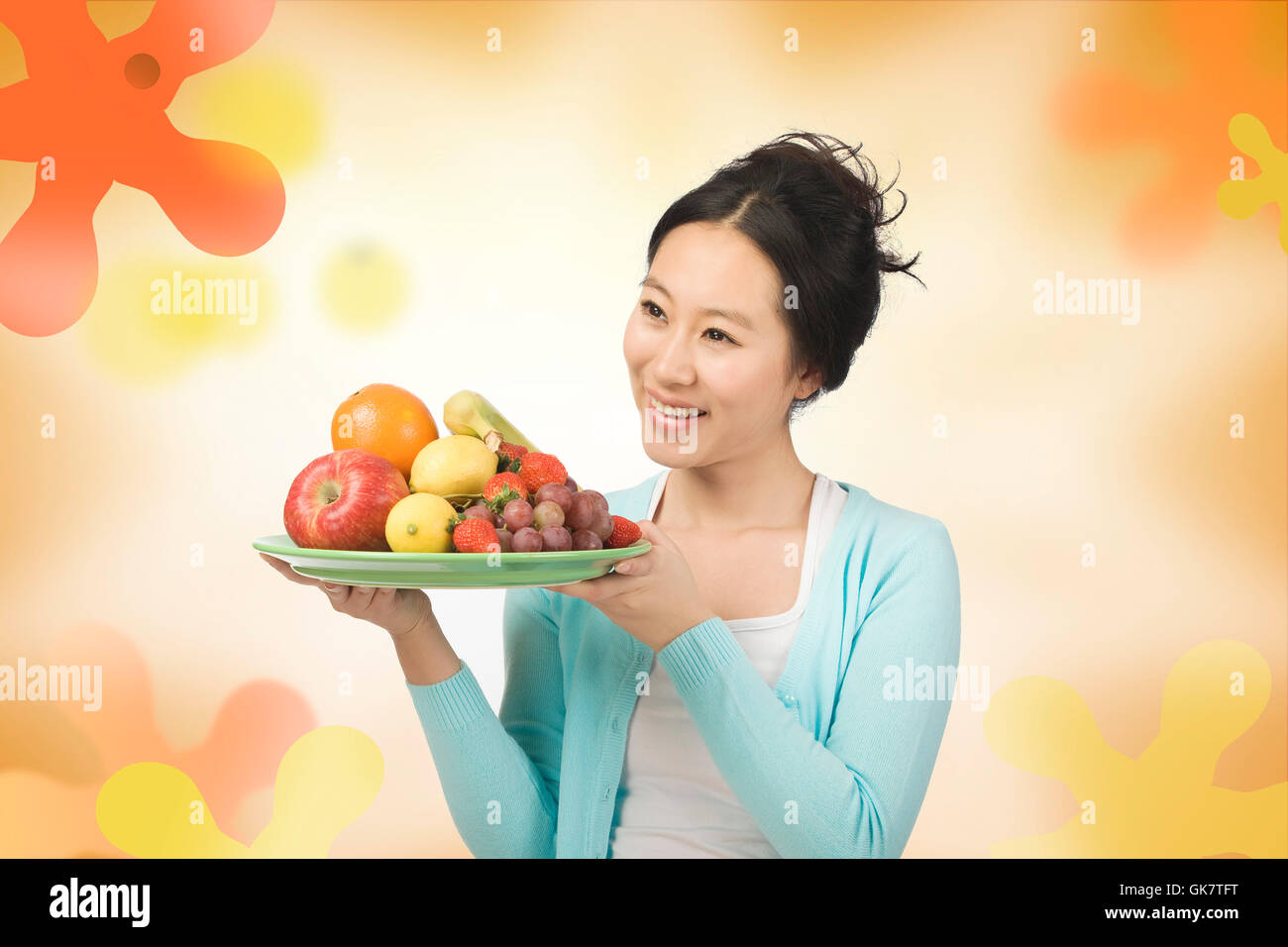 Studio shot Young woman and fruit Stock Photo - Alamy