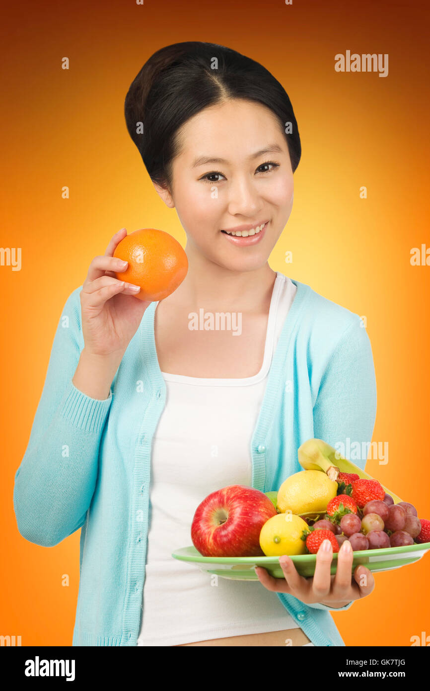 Studio shot Young woman and fruit Stock Photo - Alamy