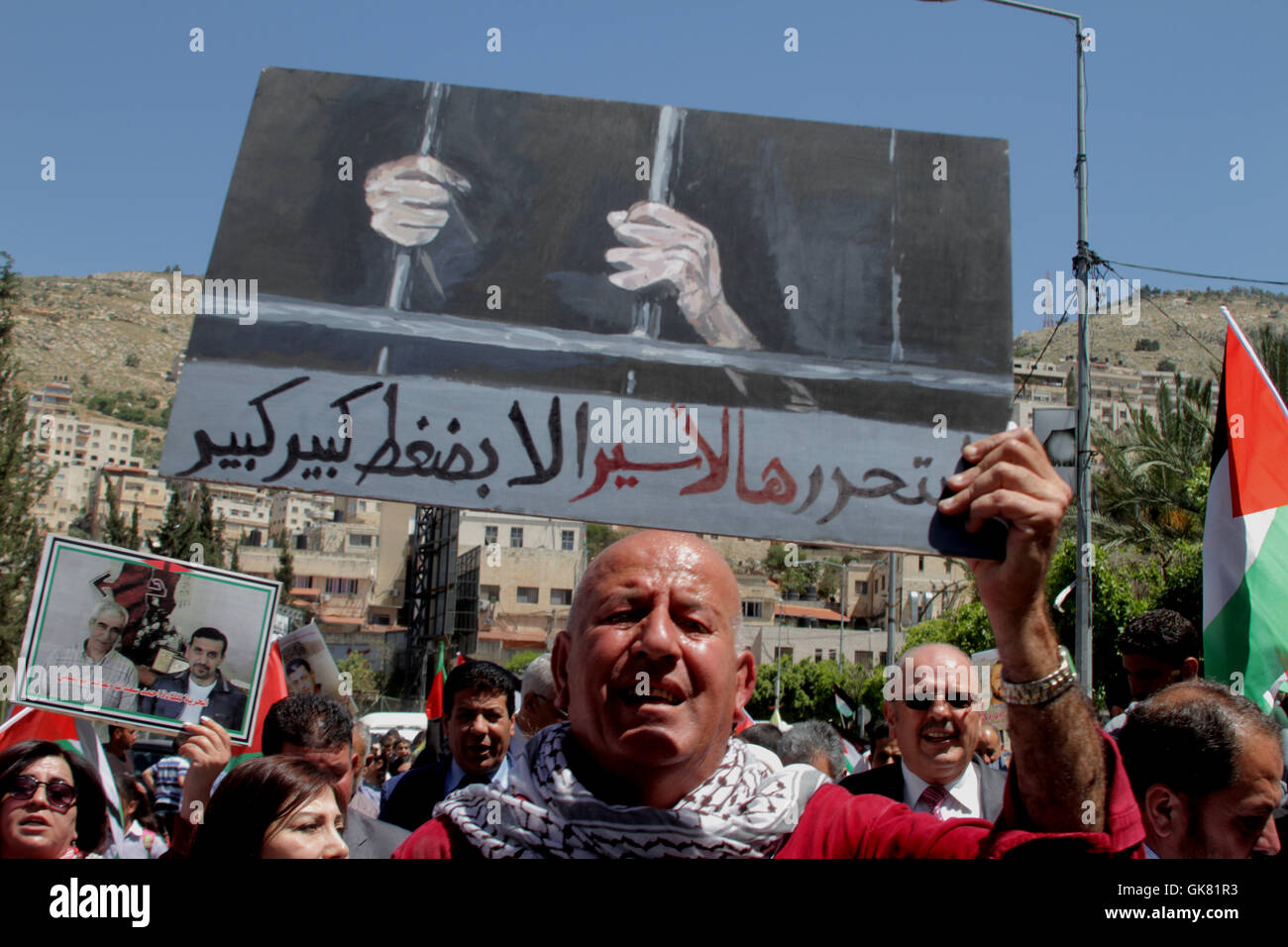 West Bank, Palestine. 18th Aug, 2016. Palestinians hold pictures of ...