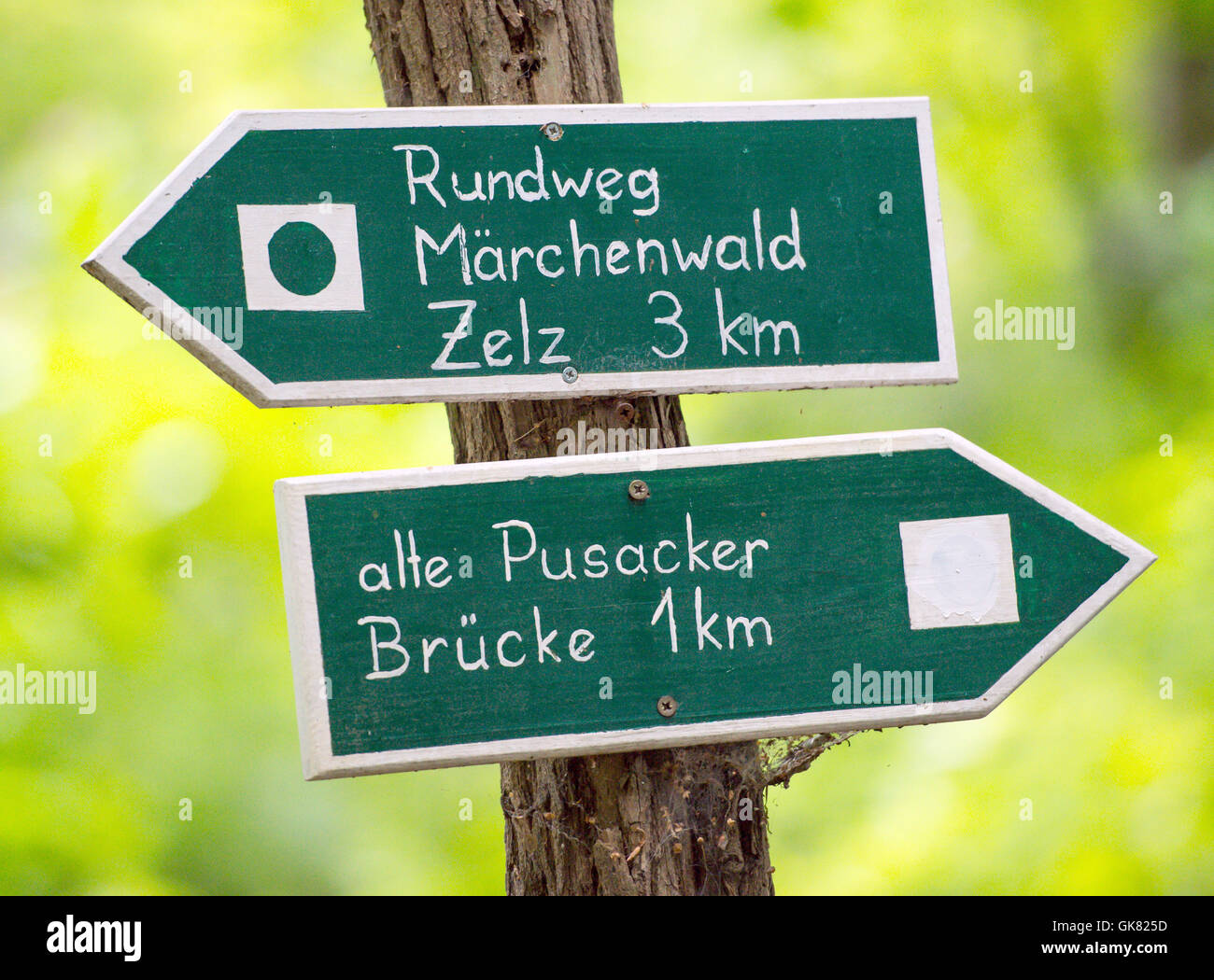 Walking signs attached to a wooden post, along the Maerchenwald ...