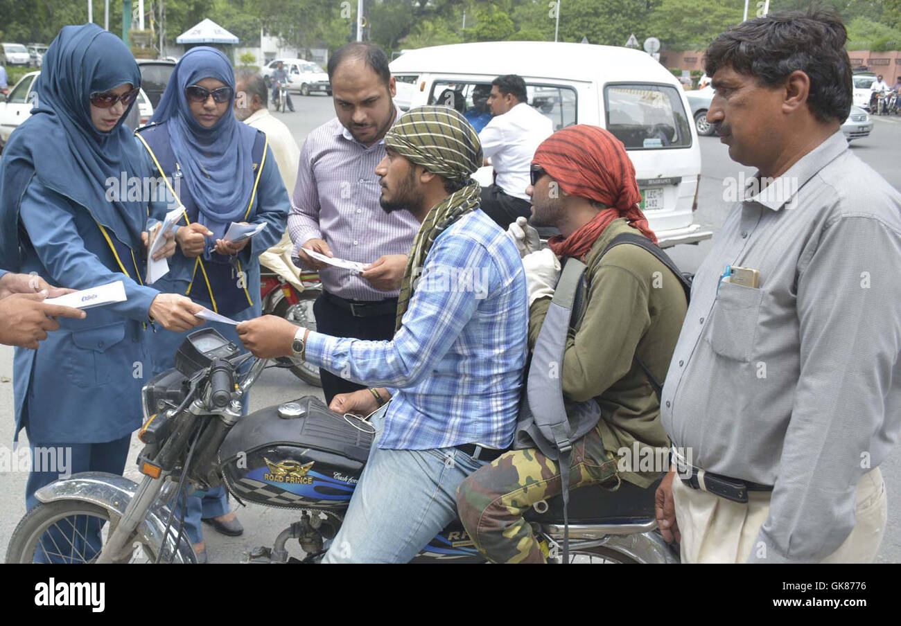 Lady traffic wardens are distributing pamphlets during the campaign ...