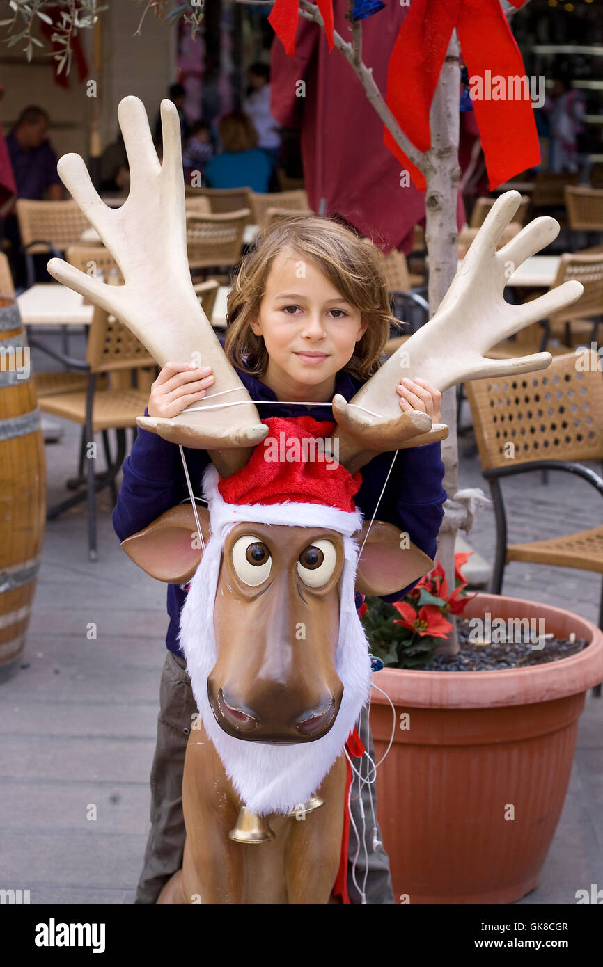 Girl and Christmas reindeer Stock Photo - Alamy