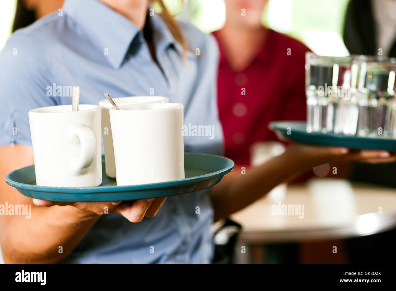 woman as a waitress in a restaurant Stock Photo - Alamy