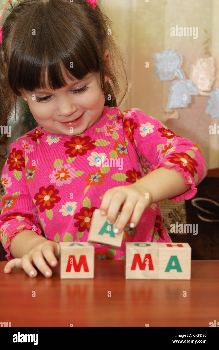 The girl and word mama from cubes Stock Photo - Alamy