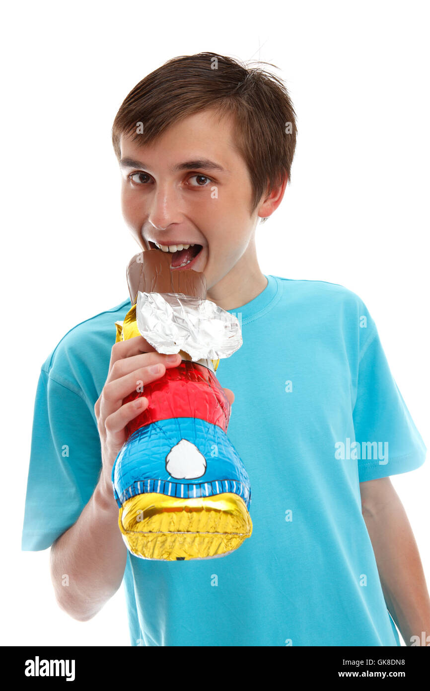 Smiling happy child eating chocolate easter Stock Photo - Alamy