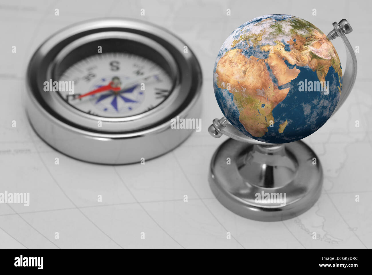 Compass and earth Stock Photo - Alamy