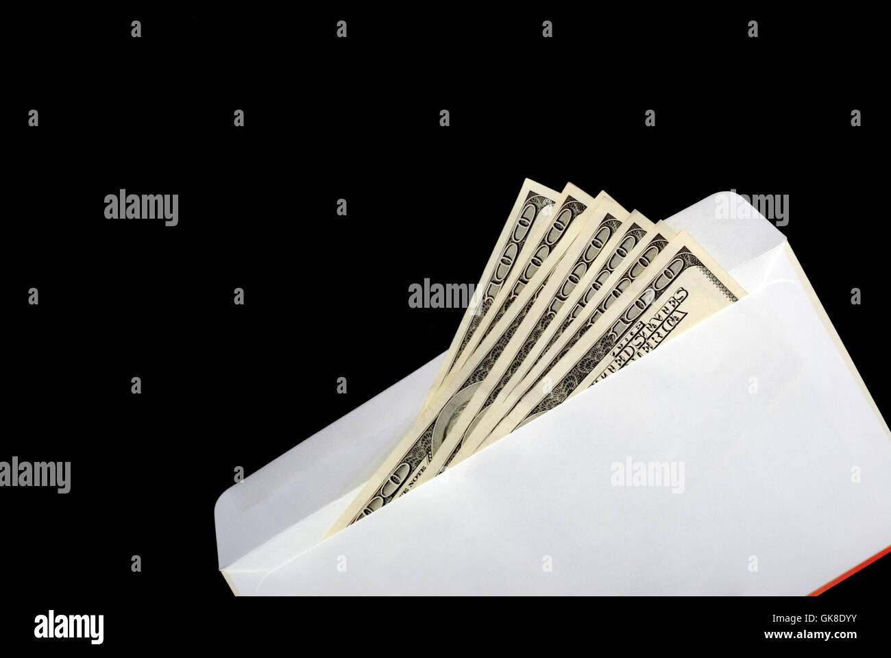 Bribe in an envelope black background Stock Photo - Alamy