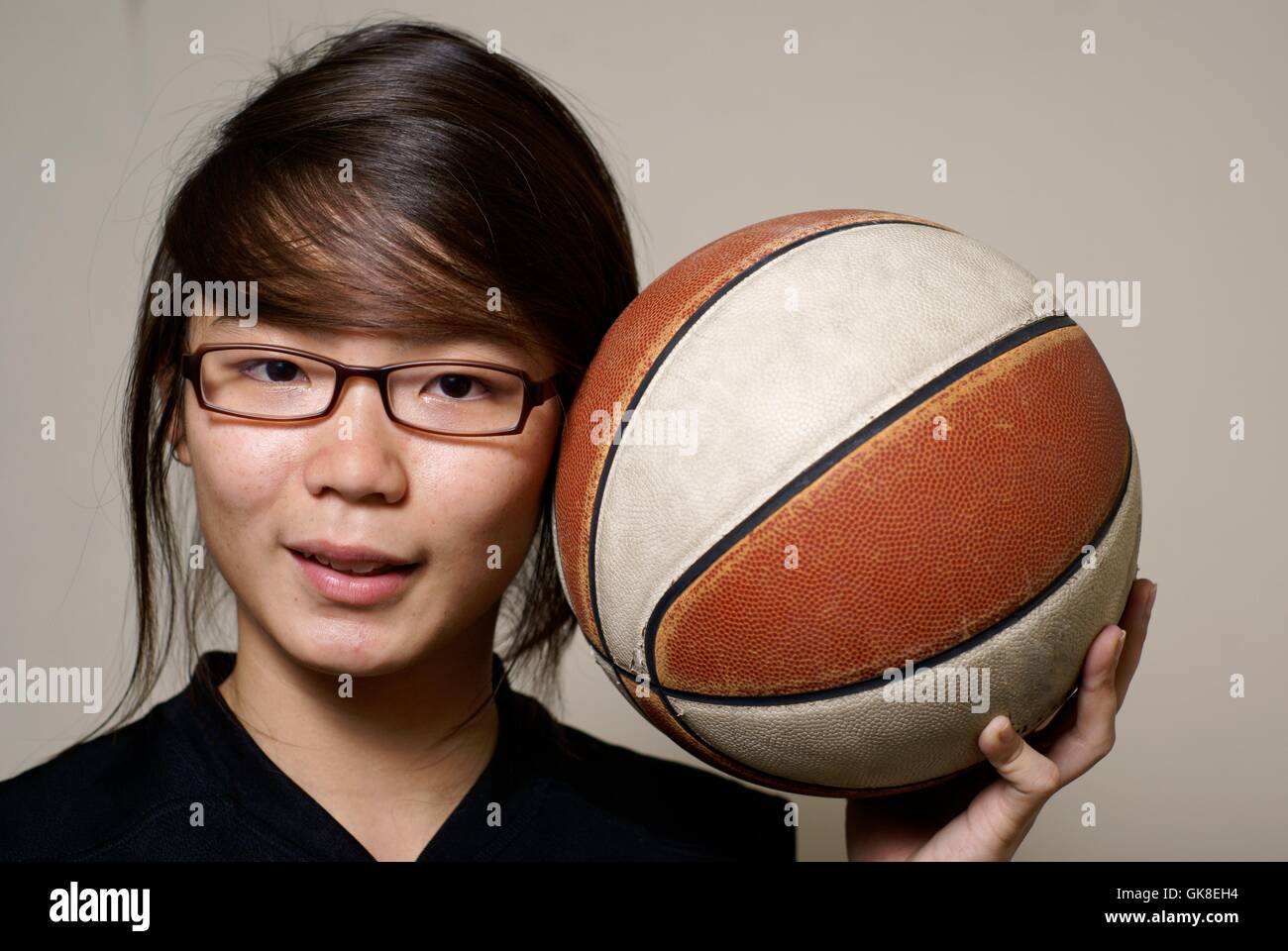 Asian female basketball player and ball Stock Photo - Alamy