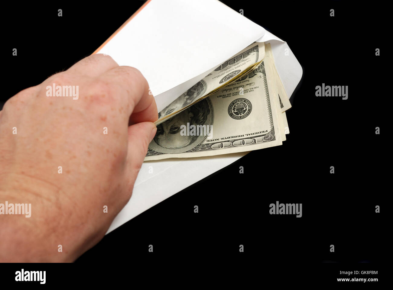 Bribe in an envelope and hand Stock Photo - Alamy
