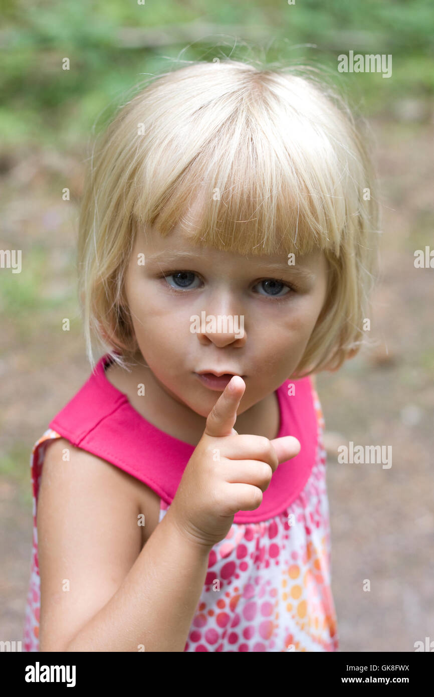 A little girl hushing Stock Photo - Alamy