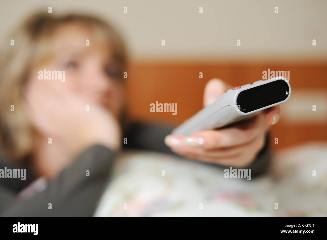 The woman with a television control panel. Selective focus Stock Photo ...