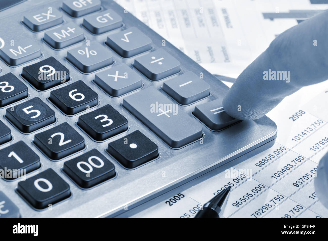 The calculator and a hand of the man Stock Photo - Alamy