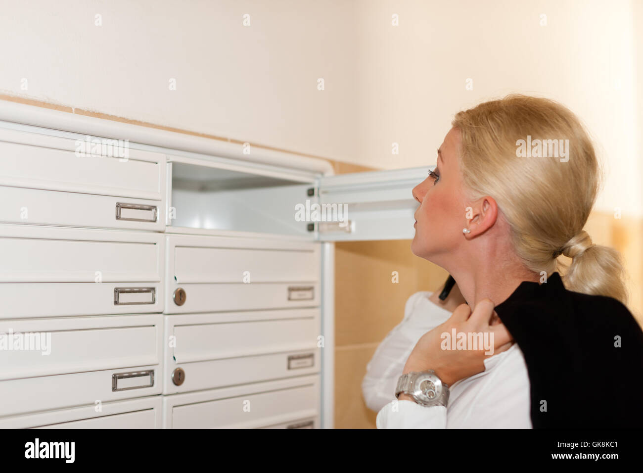 woman looks at her post in the letterbox Stock Photo - Alamy