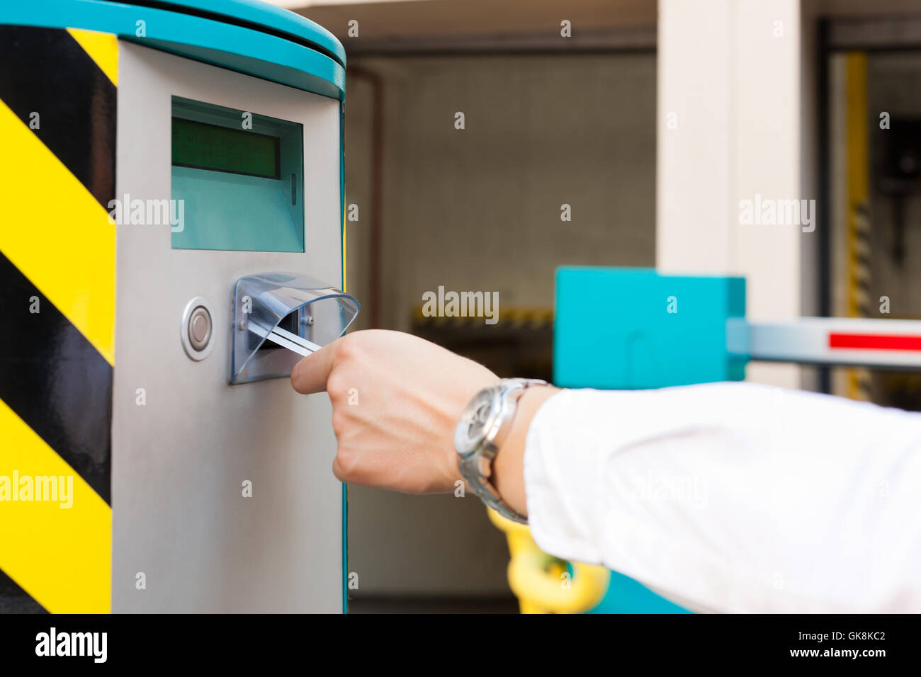 hand pushes parking ticket in parking barrier Stock Photo - Alamy