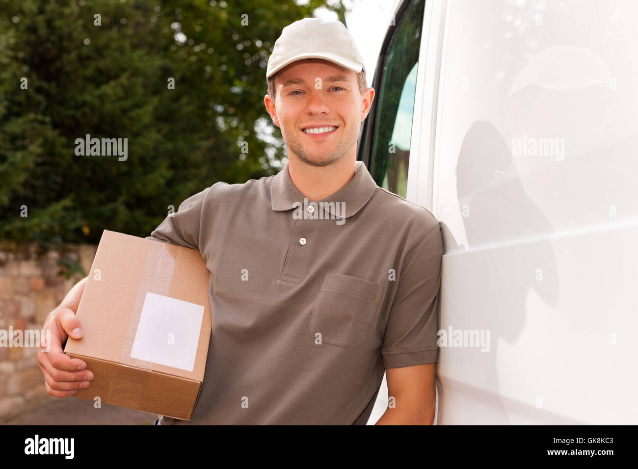 postal service - delivery of a parcel Stock Photo - Alamy
