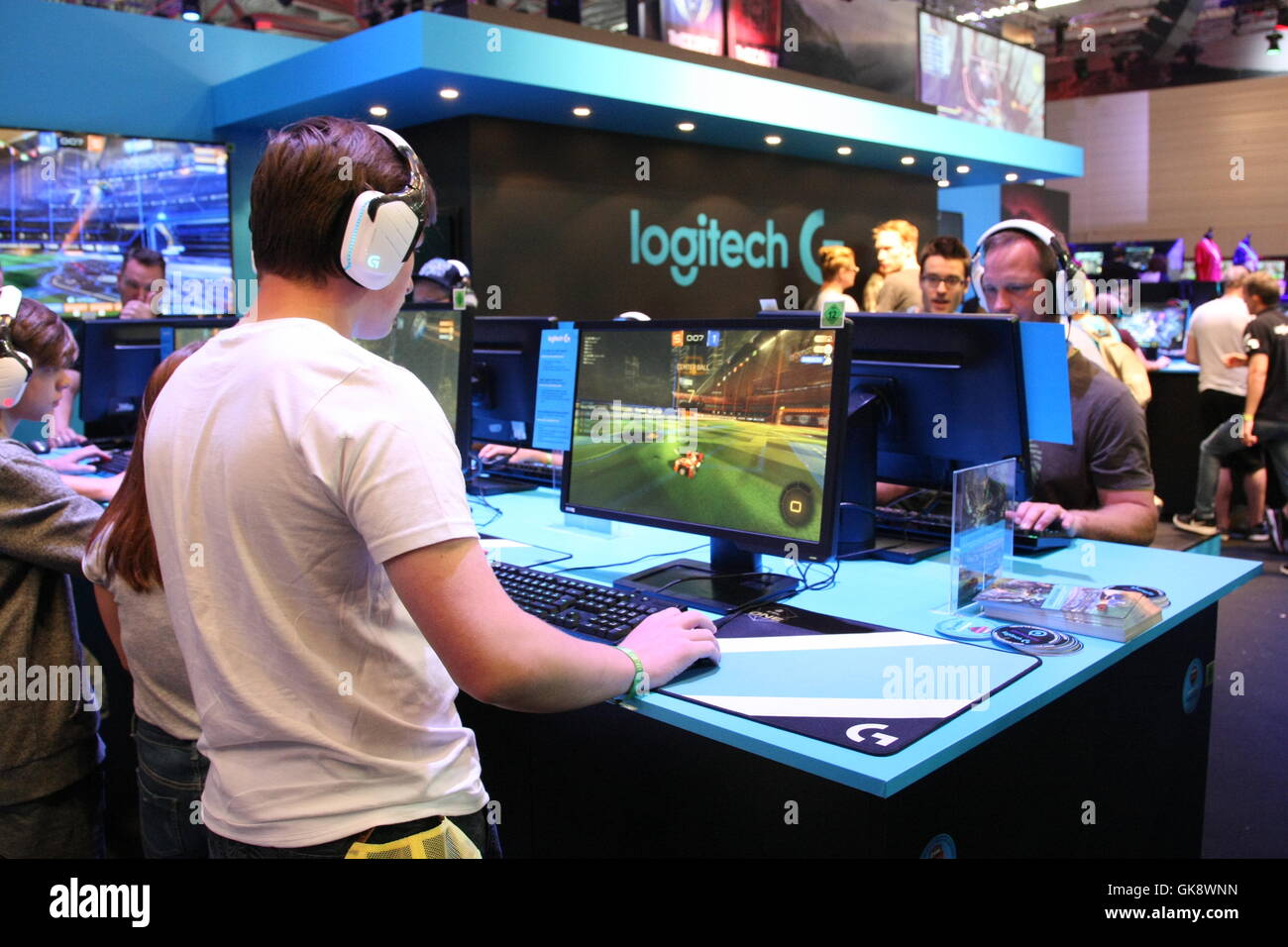 Cologne, Germany. 18th Aug, 2016. A Visitor plays at the Logitech stand ...