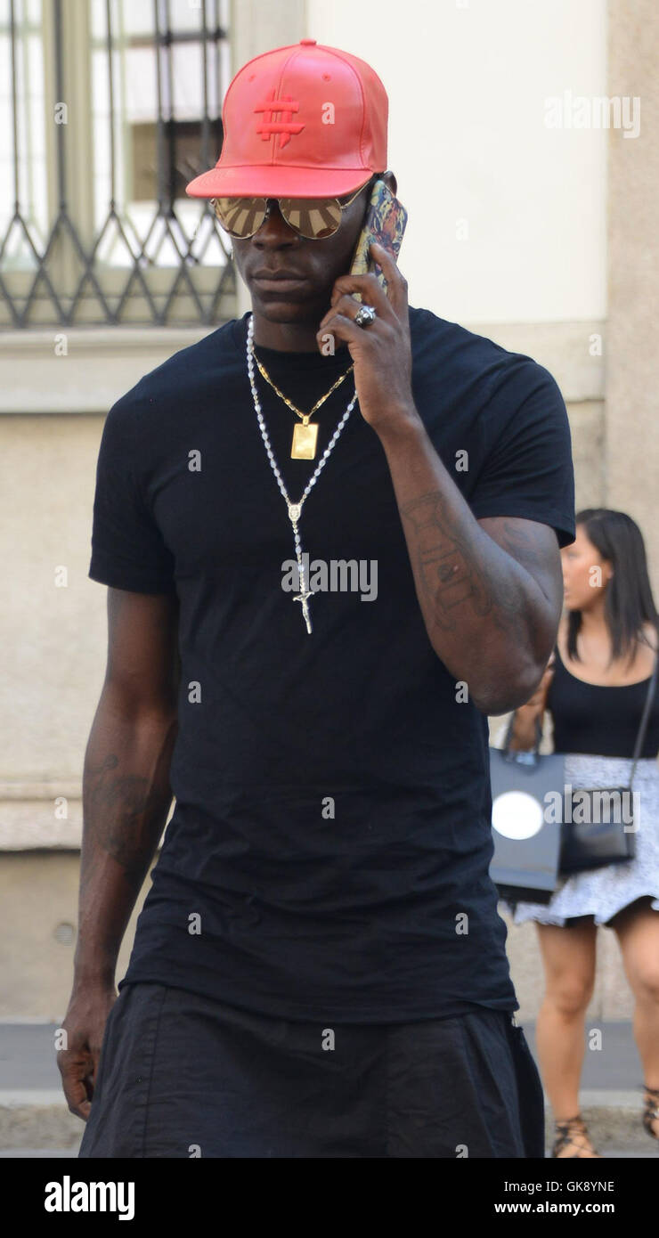 Mario Balotelli and his brother Enock Barwuah in downtown Milan ...
