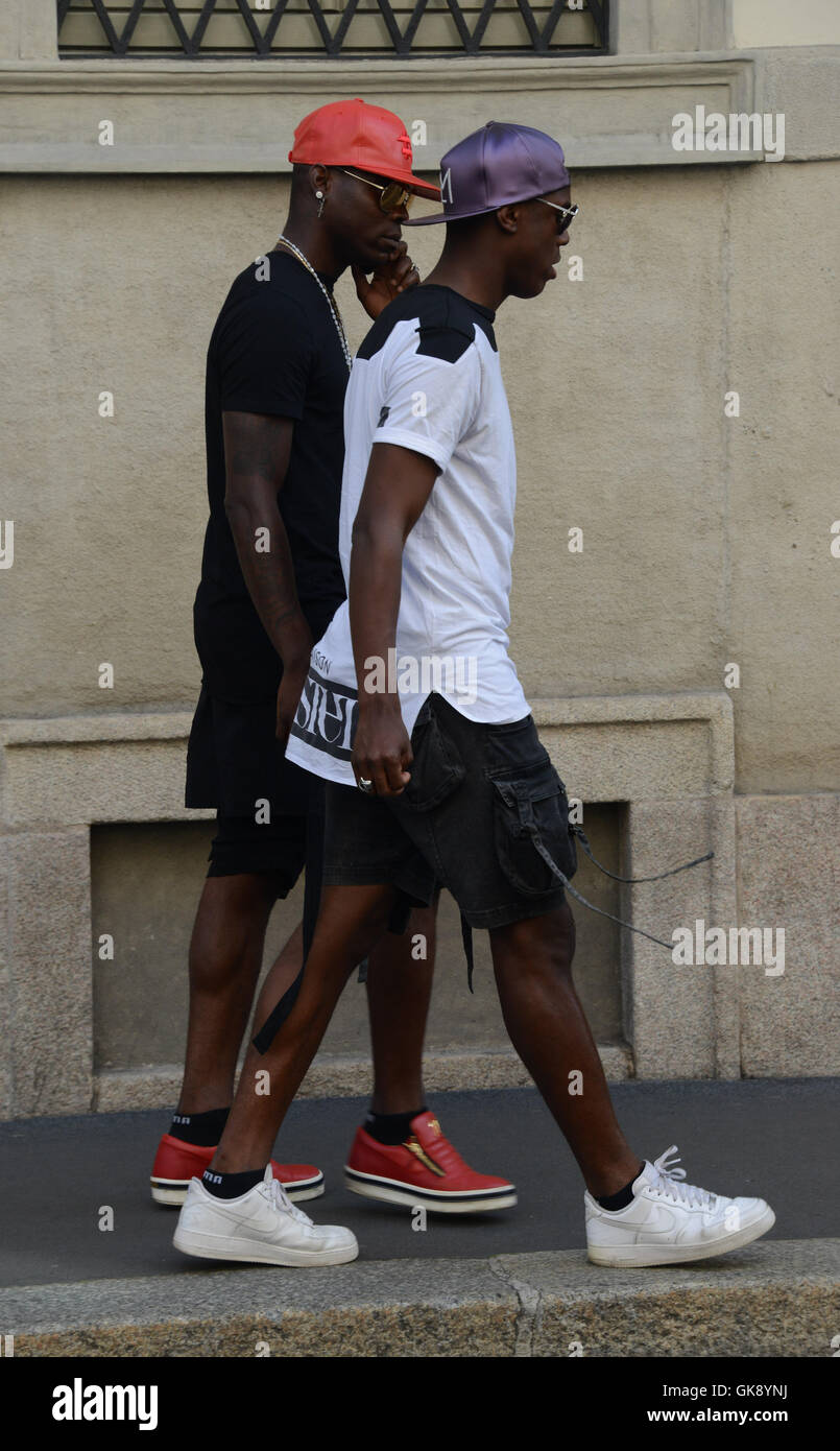 Mario Balotelli and his brother Enock Barwuah in downtown Milan ...