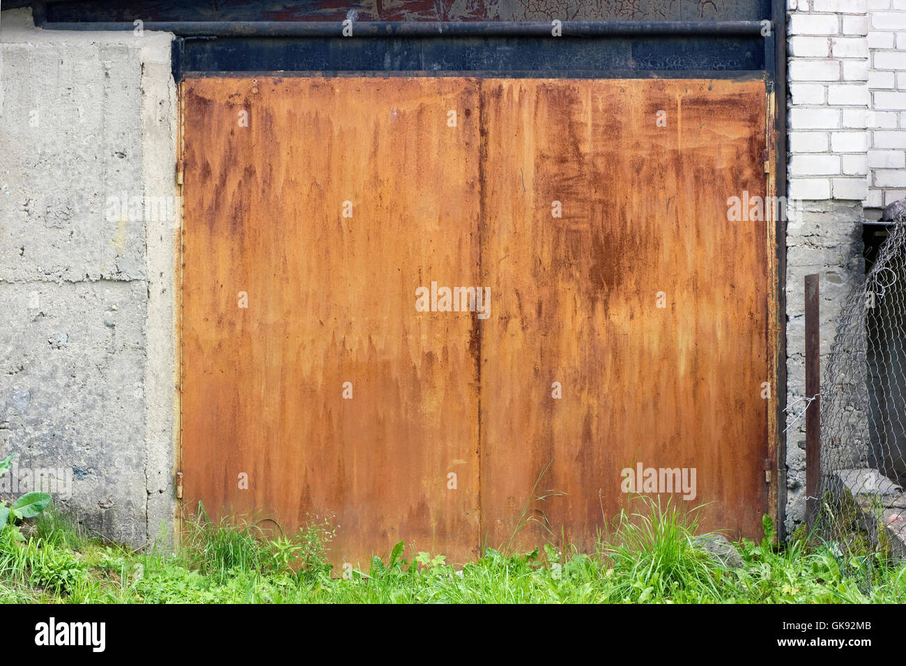 Rusty steel gate of this rural garage never opened. The entrance has ...