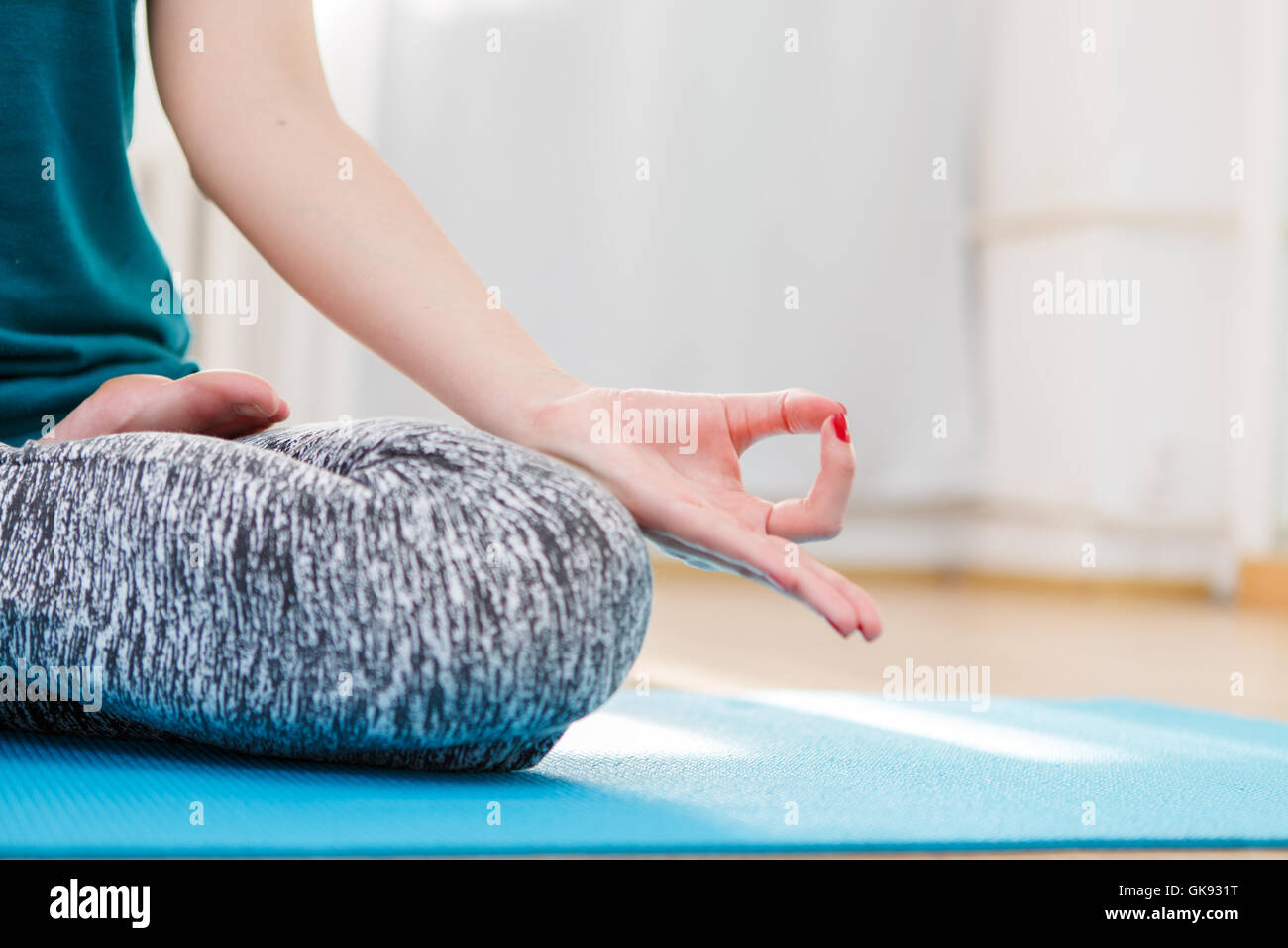 Woman relaxing in lotus asana with hand gestures Zen Stock Photo - Alamy