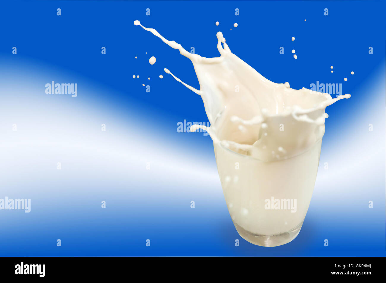 Glass of milk are splashing on a blue background. Objects with Clipping ...