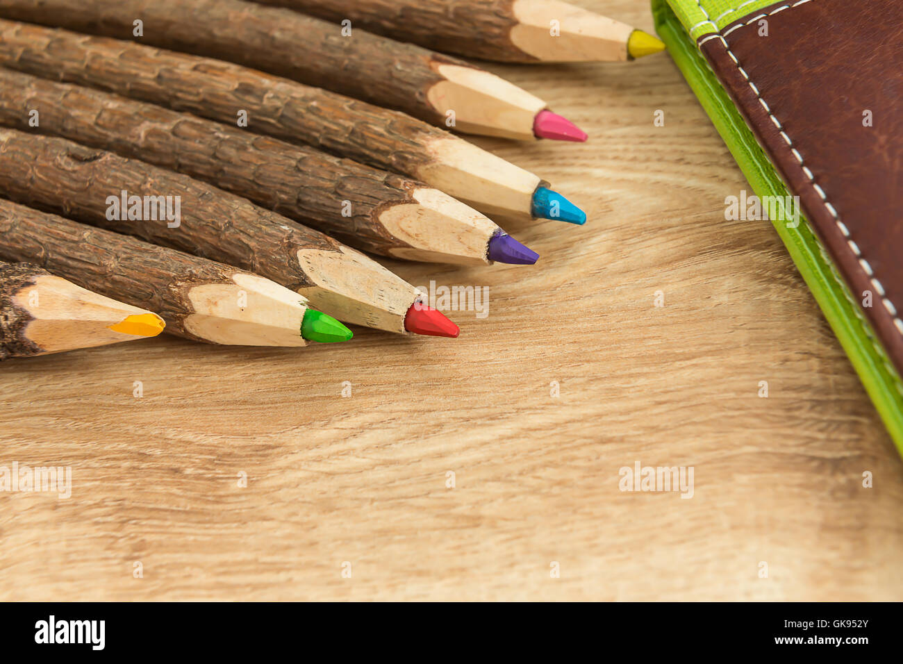 wood colored natural pencils and leather notebook on the desk Stock ...