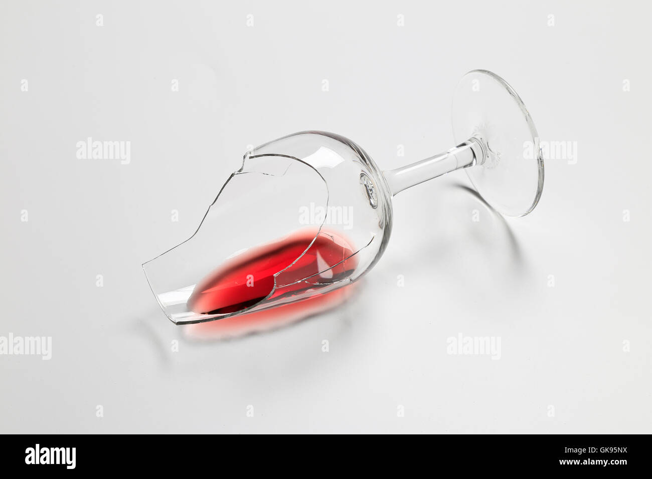Broken Red Wine tasting glass with wine Stock Photo - Alamy