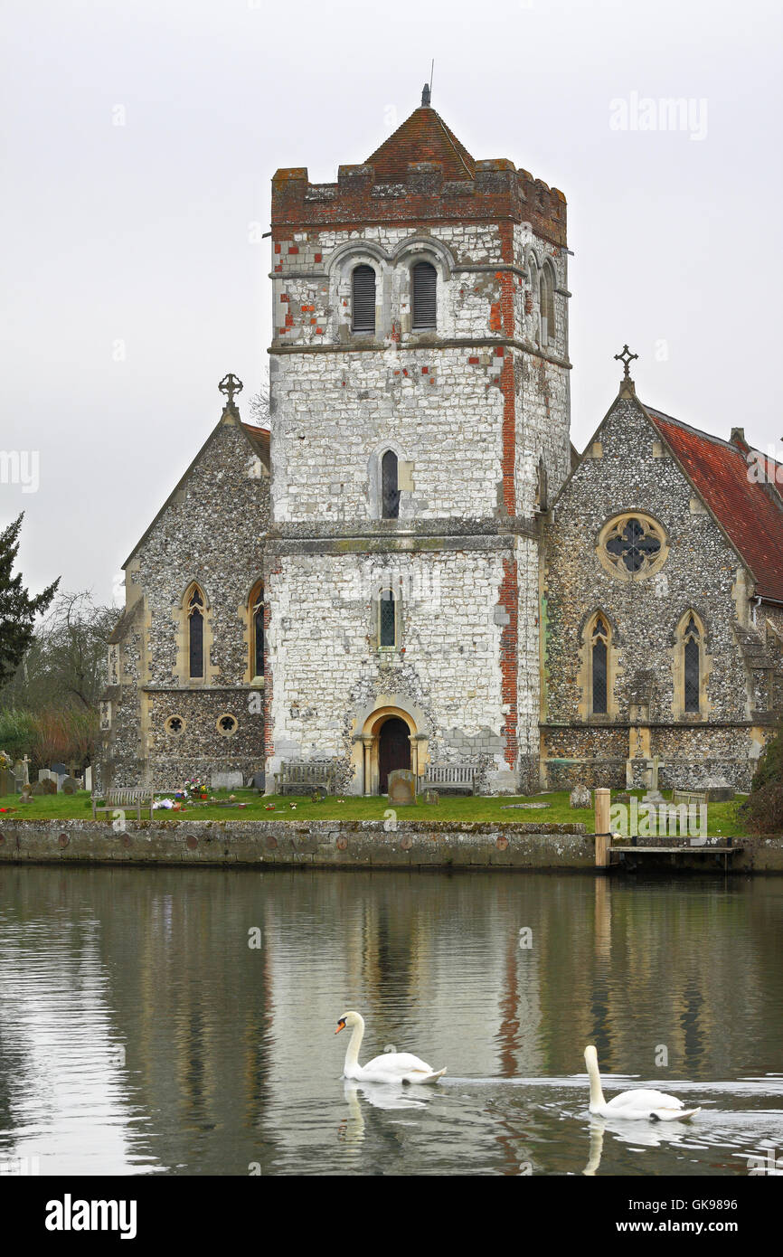 Swans passing Bisham Church on the River Thames in Bucks Stock Photo ...