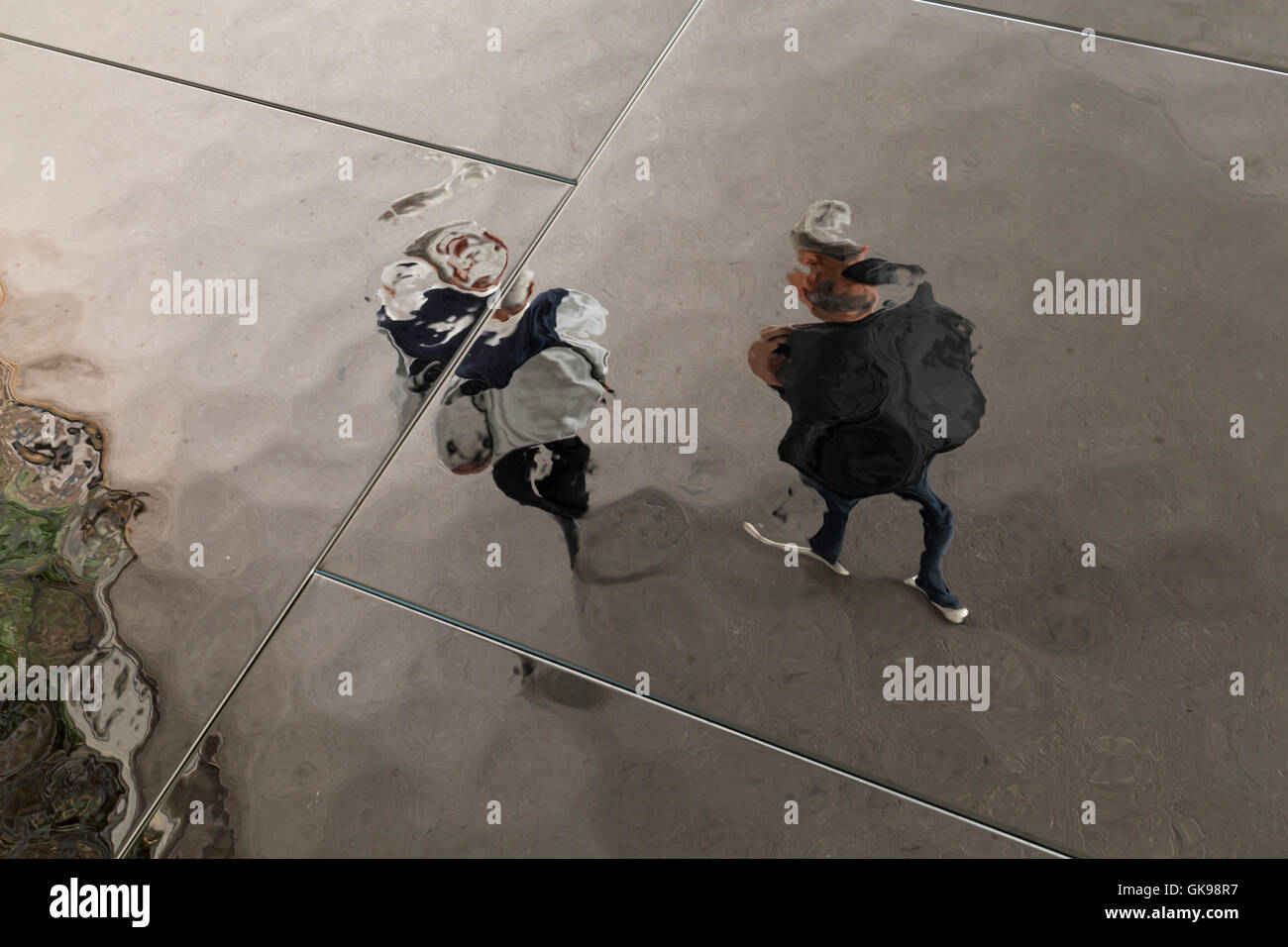 contorted reflections of people in a ceiling with mirrors Stock Photo ...